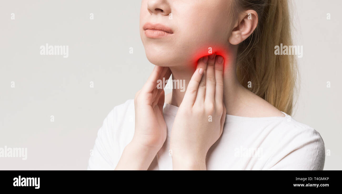 Woman with thyroid gland problem, touching her neck Stock Photo - Alamy