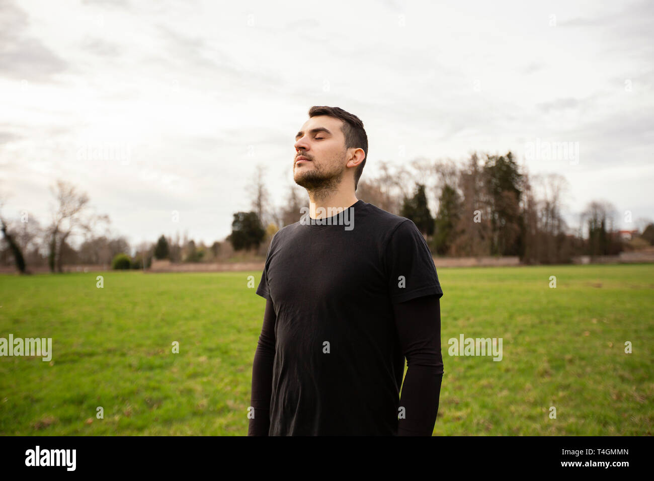 Man relaxing and breathing fresh air in a city park .Handsome man deep ...
