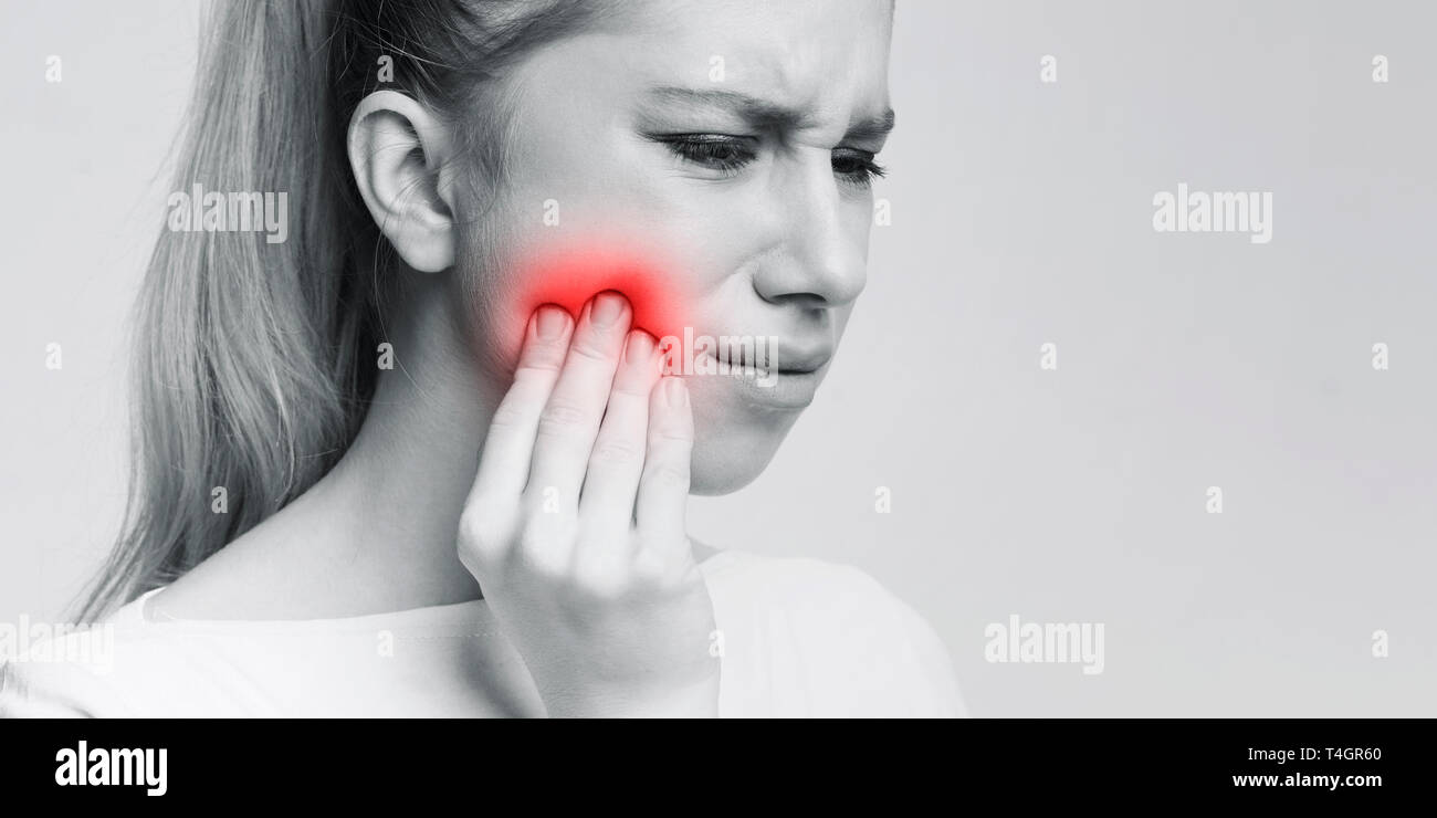 Teeth problem. Woman suffering from strong tooth pain, monochrome photo ...