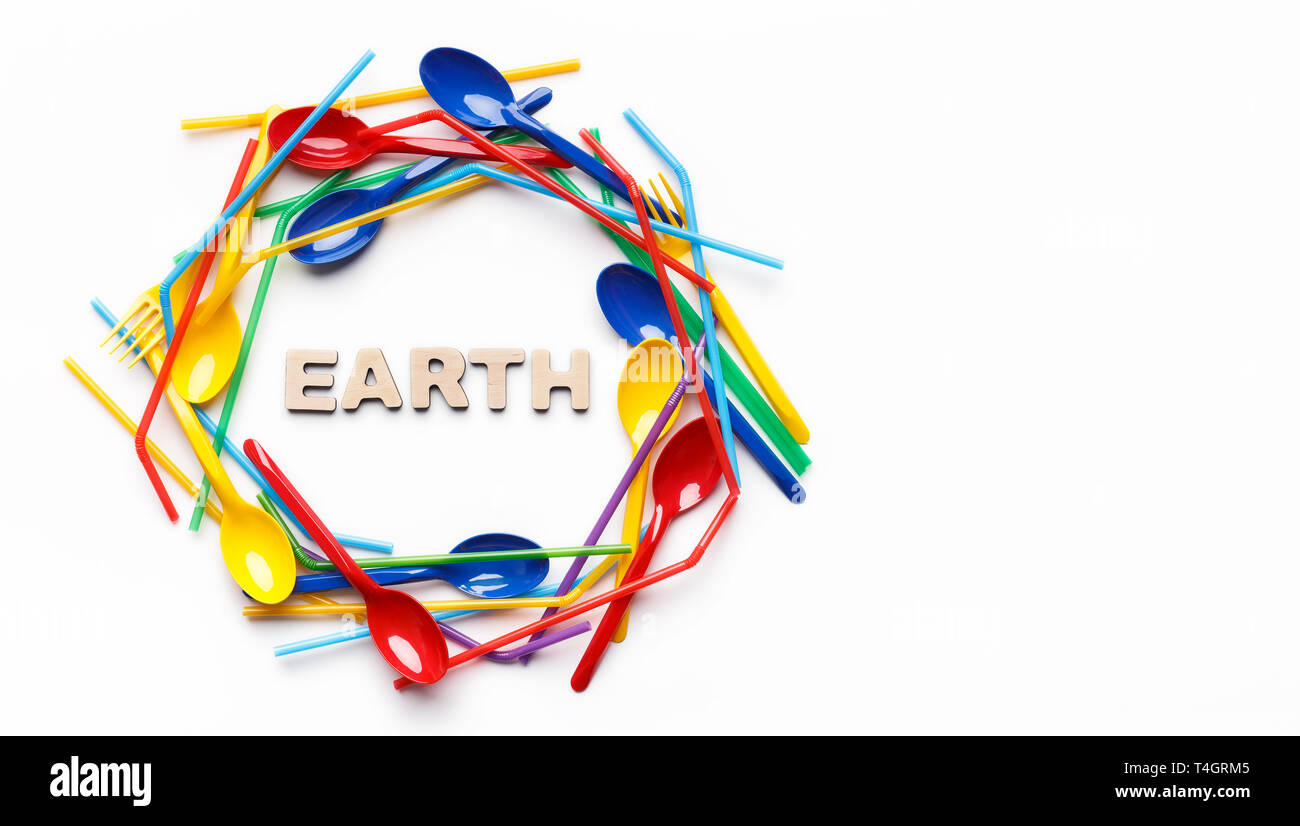 Colored single-use plastic forks and spoons in round shape on white ...