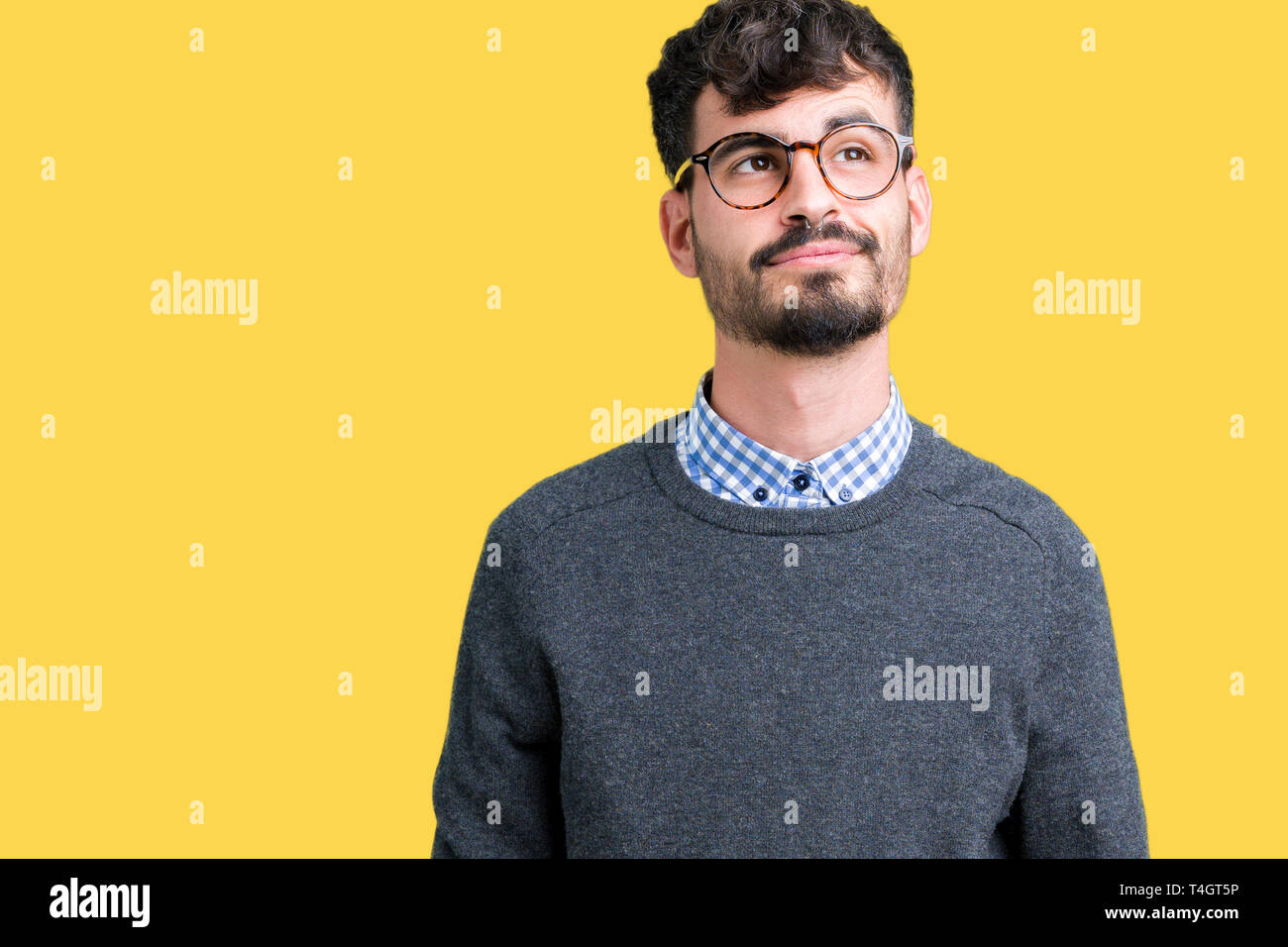 Young handsome smart man wearing glasses over isolated background ...
