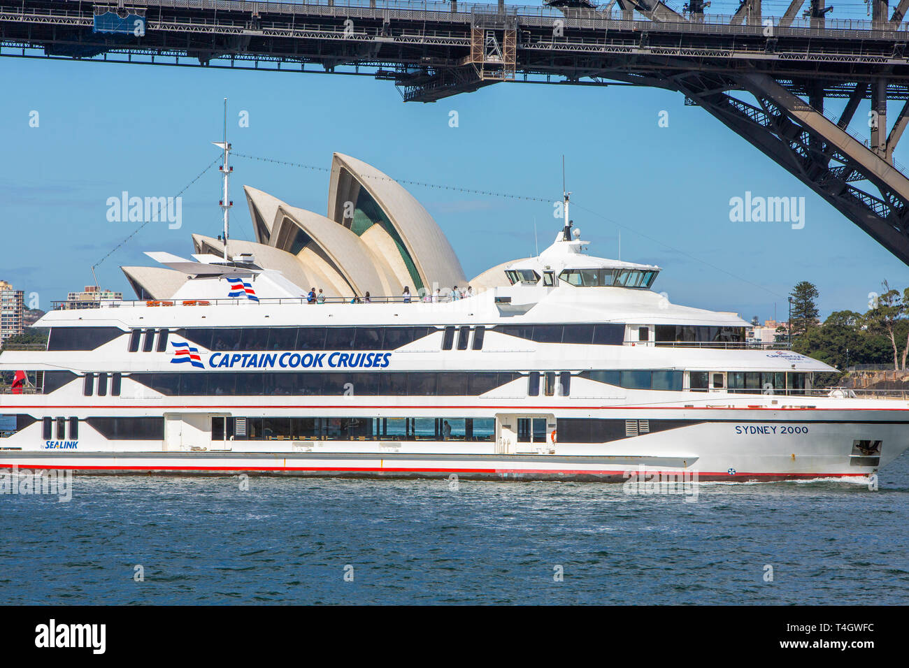 Captain Cook cruise boat passes Sydney opera house and harbour bridge ...
