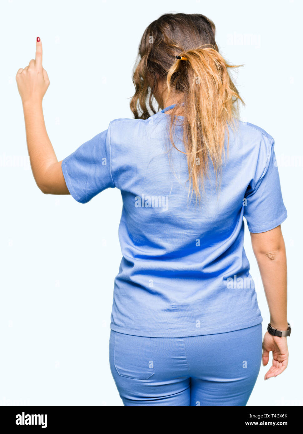 Young adult doctor woman wearing medical uniform Posing backwards ...