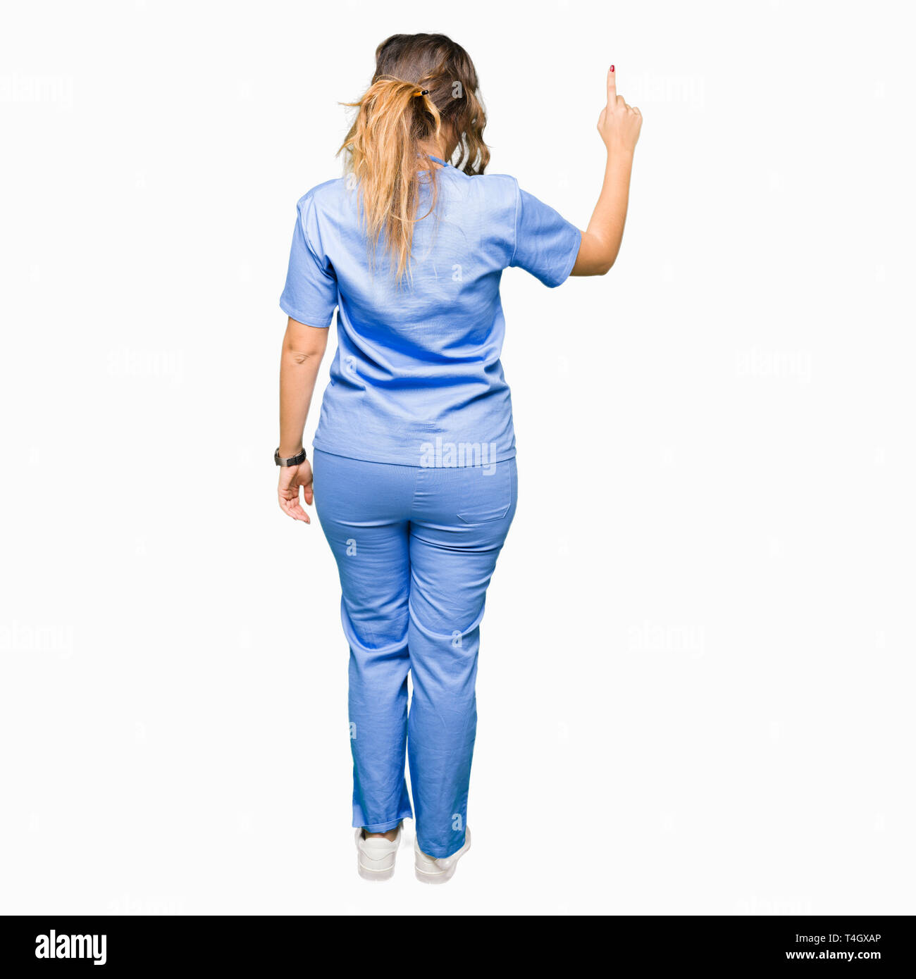 Young adult doctor woman wearing medical uniform Posing backwards ...