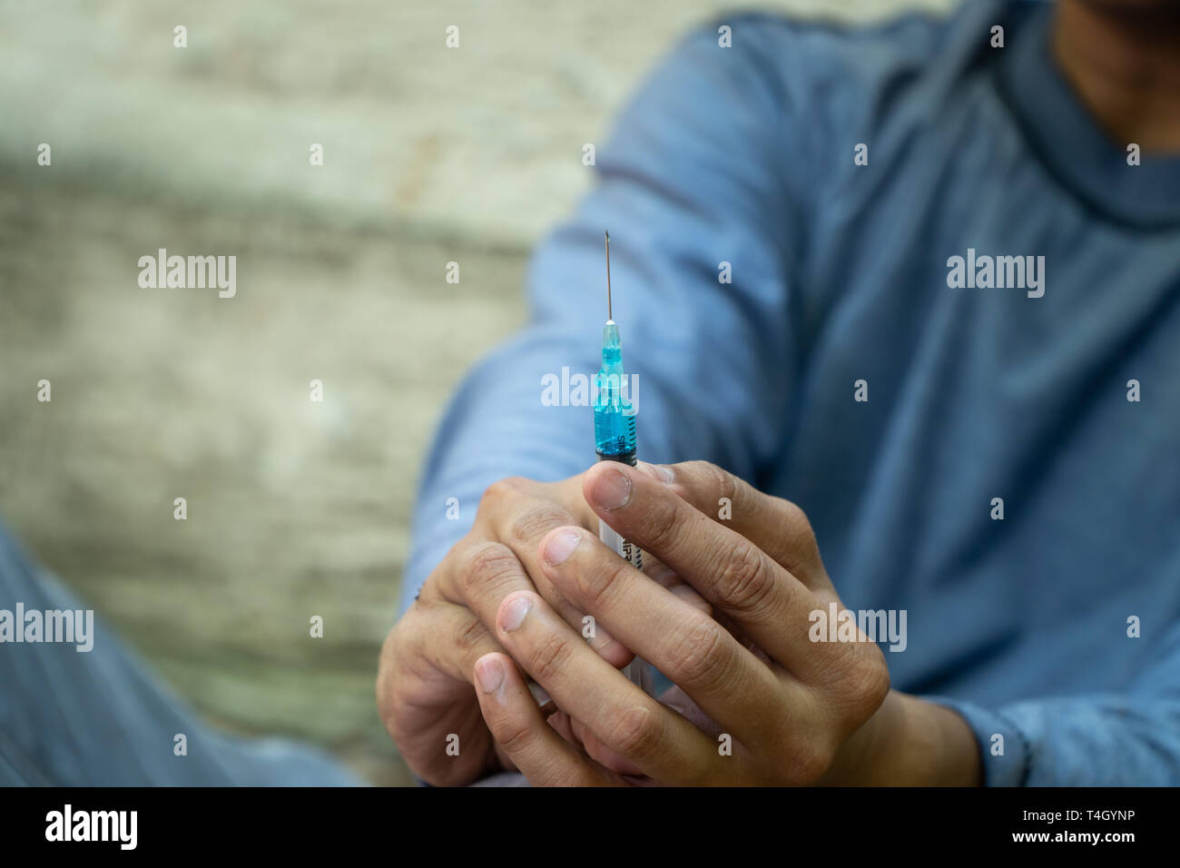 close up of Syringe and Needle in hand of drug addict man. homeless ...