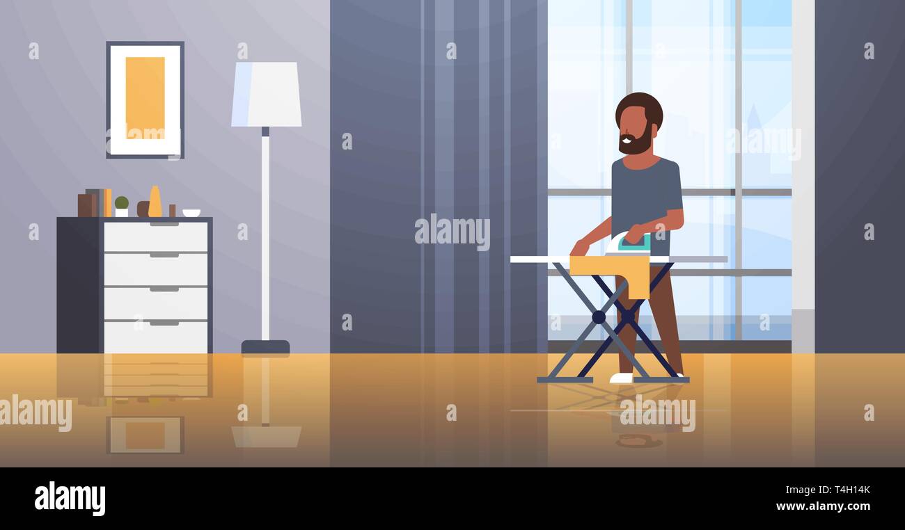 man ironing clothes african american guy holding iron doing housework ...