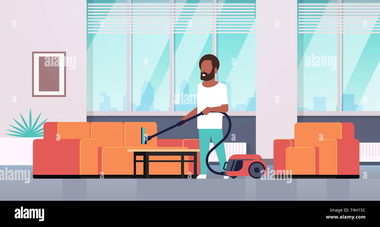 man cleaning couch with vacuum cleaner african american guy doing ...