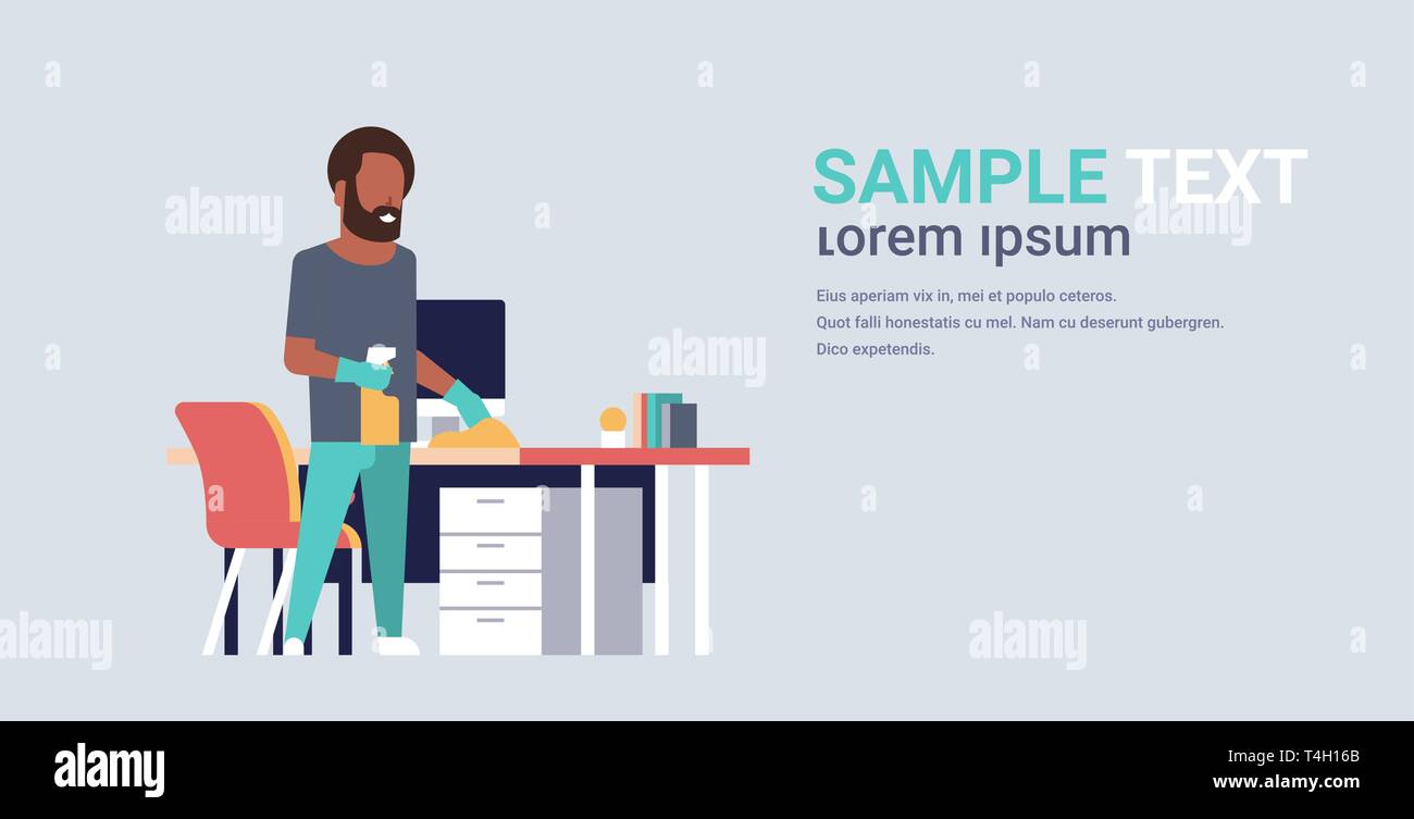 man cleaning computer table with duster african american guy wiping ...