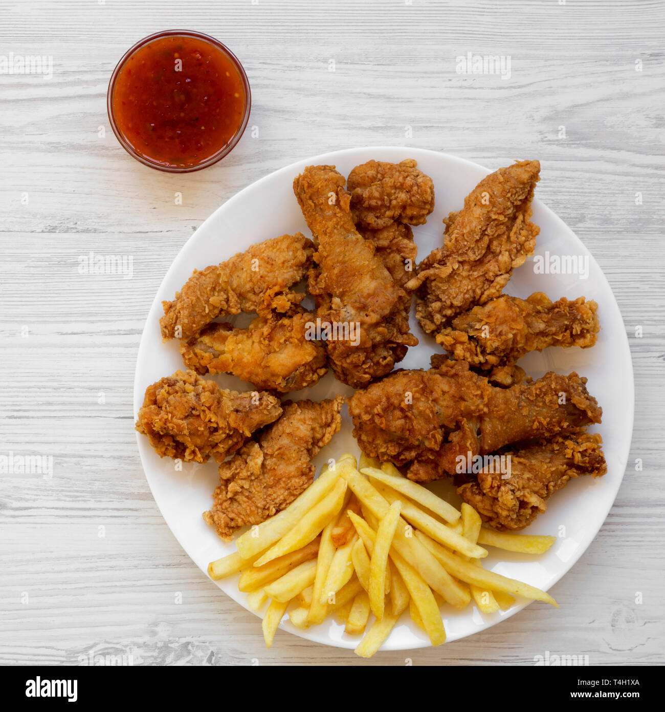 Tasty fried chicken legs, spicy wings, French fries, chicken fingers ...