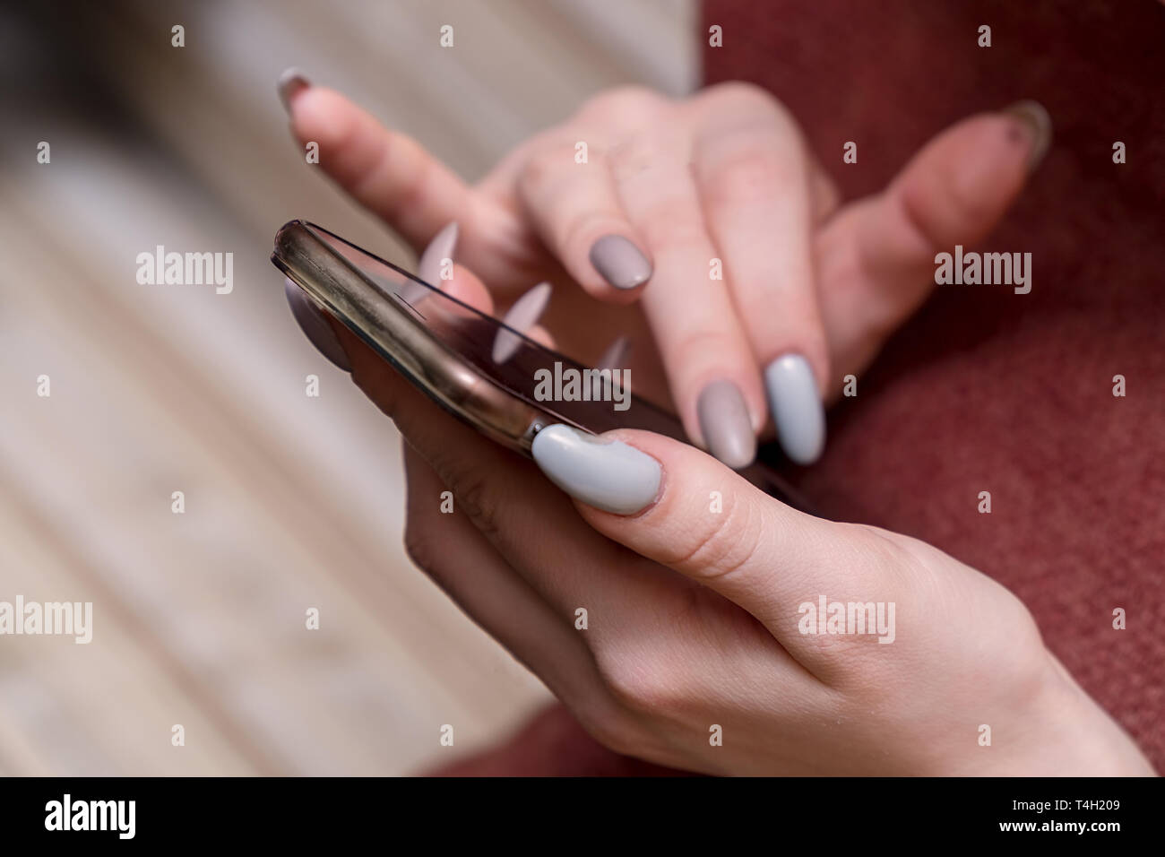The girl touches her fingers to the phone screen Stock Photo - Alamy