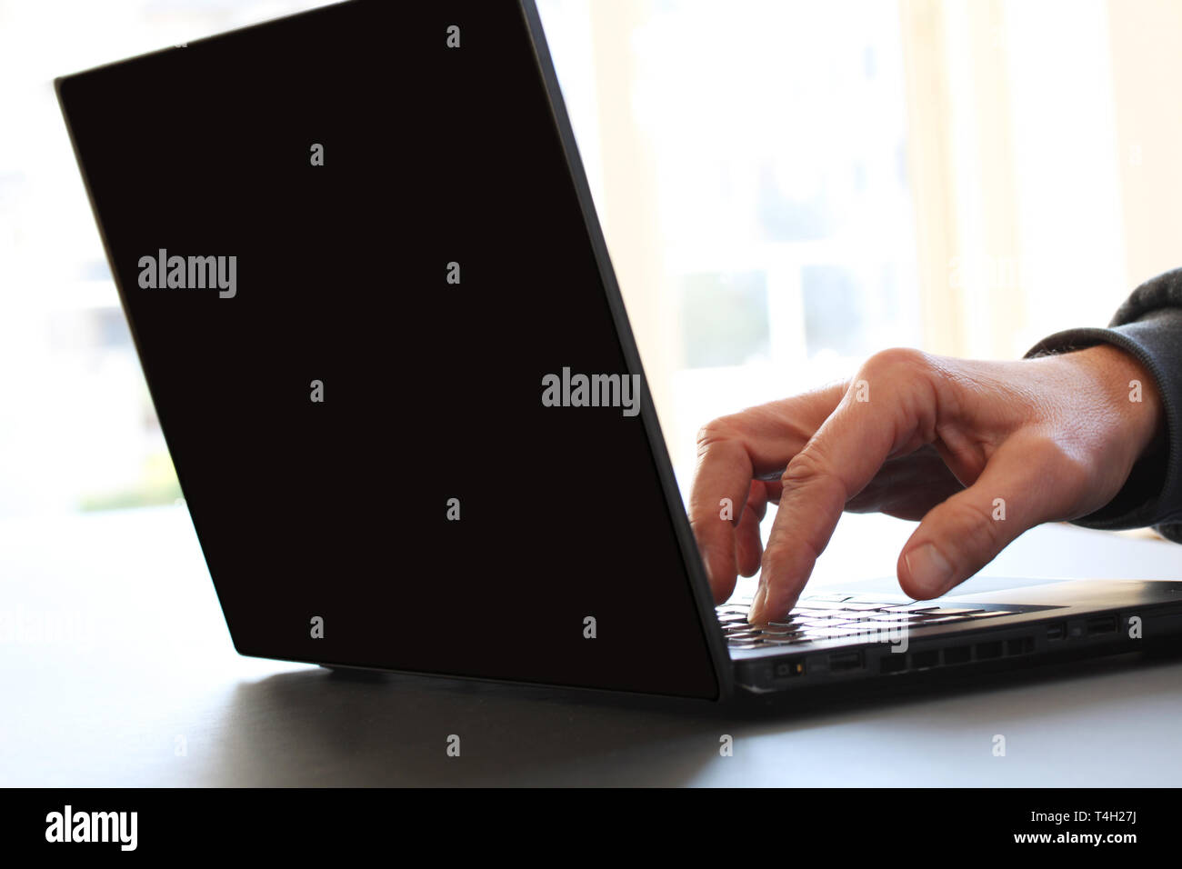 Closeup image of a finger touching texting on keyboard on a laptop ...