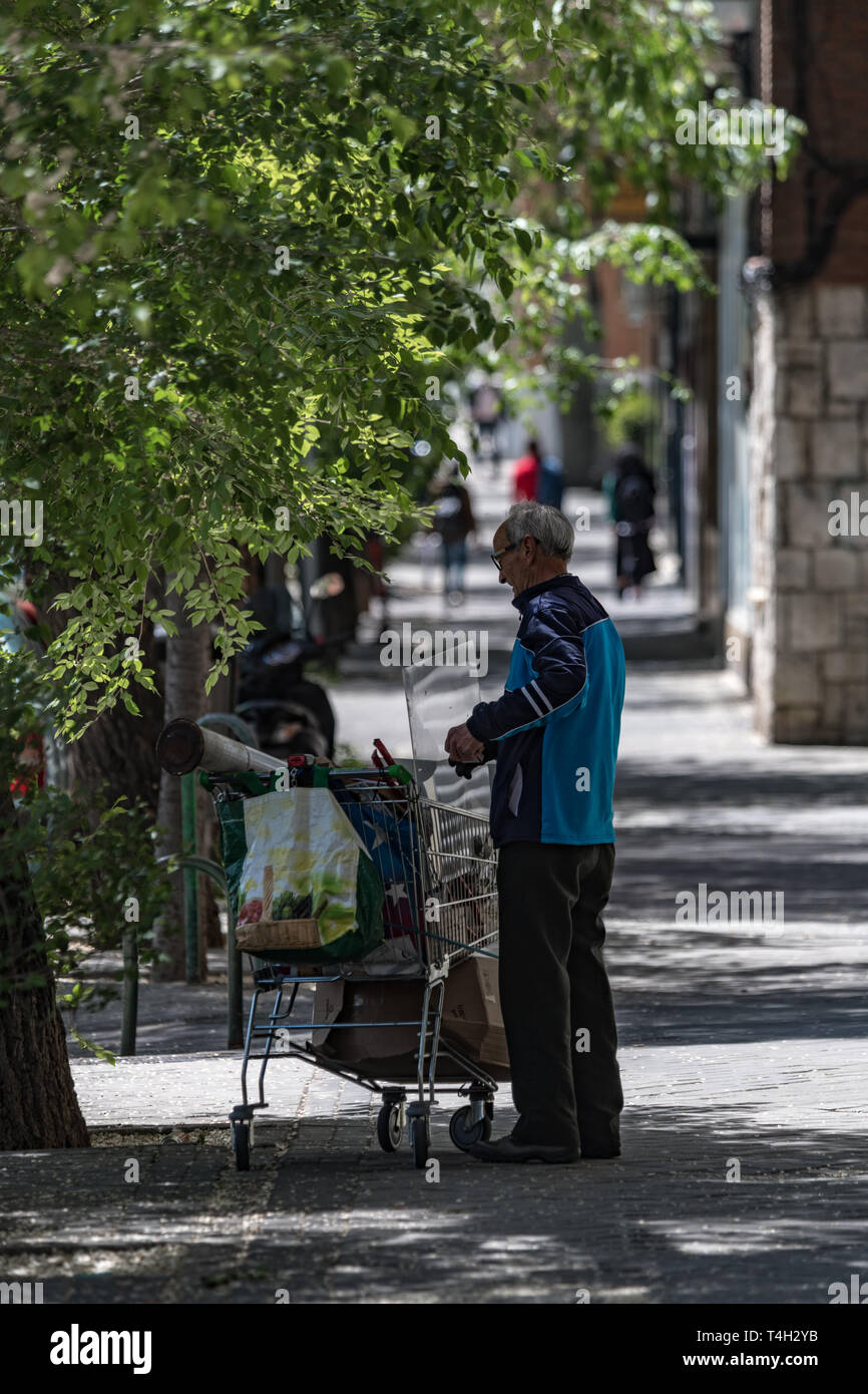 Homeless person collecting waste to recycle Stock Photo - Alamy