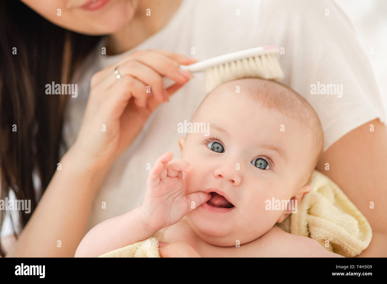 Mother combing hair of baby hi-res stock photography and images - Alamy