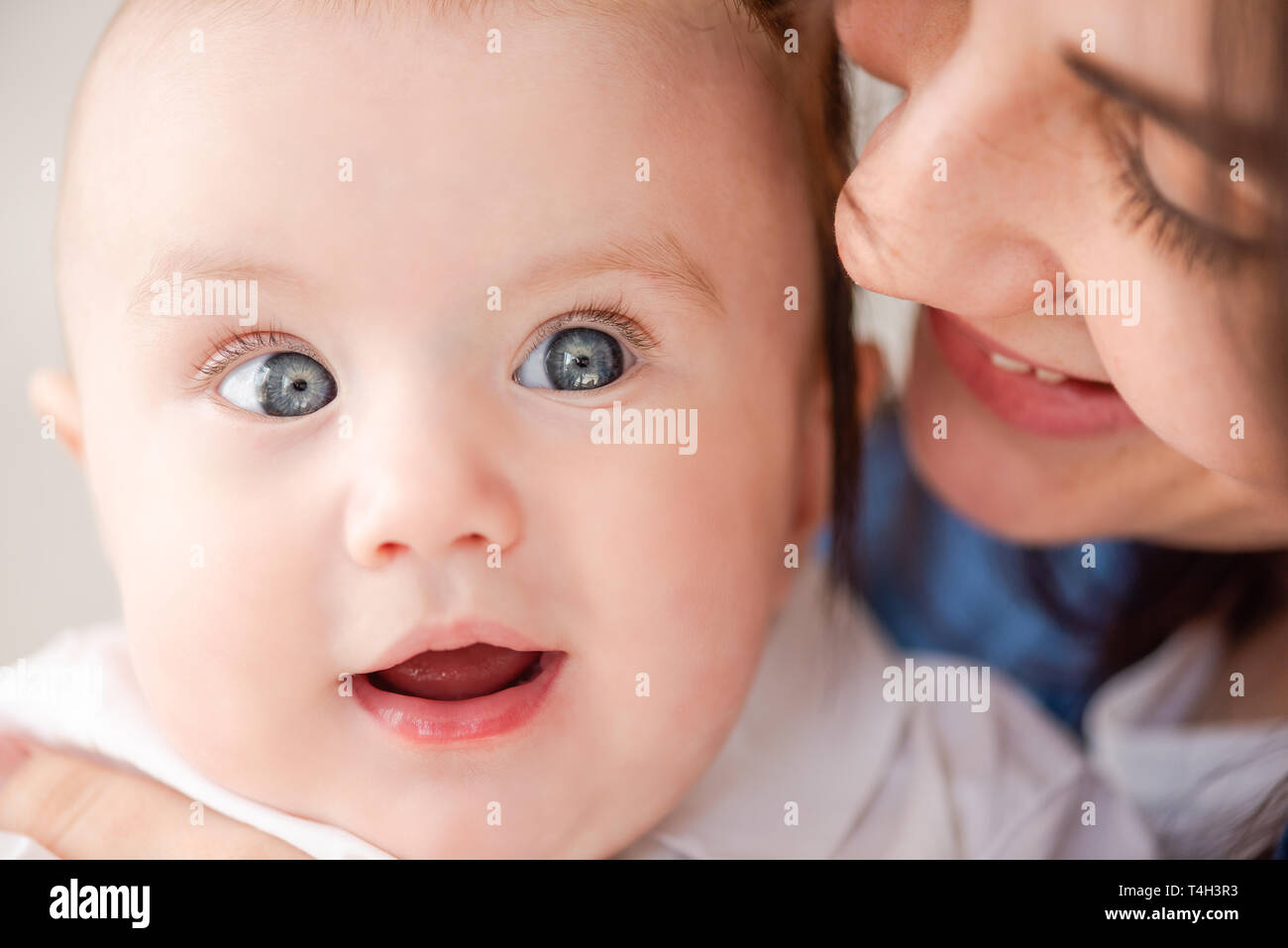 Portrait of lovely infant blue eyes in mom hugs Stock Photo - Alamy