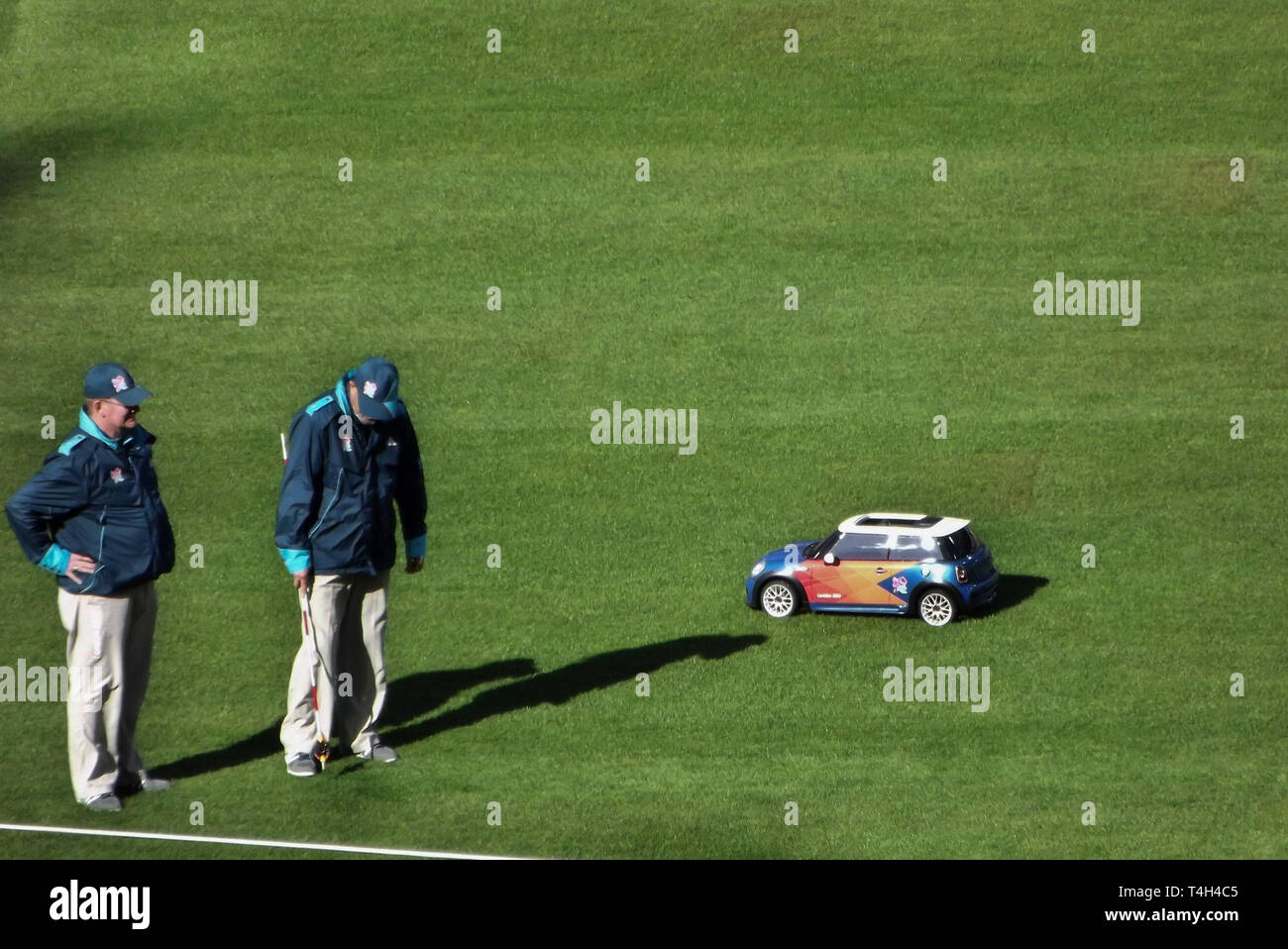 two stewards standing next to one of the remote control mini copper ...