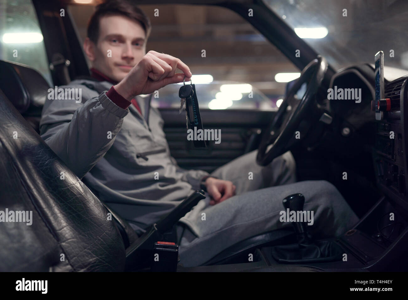 Image of side of man driver holding keys sitting in black car Stock ...