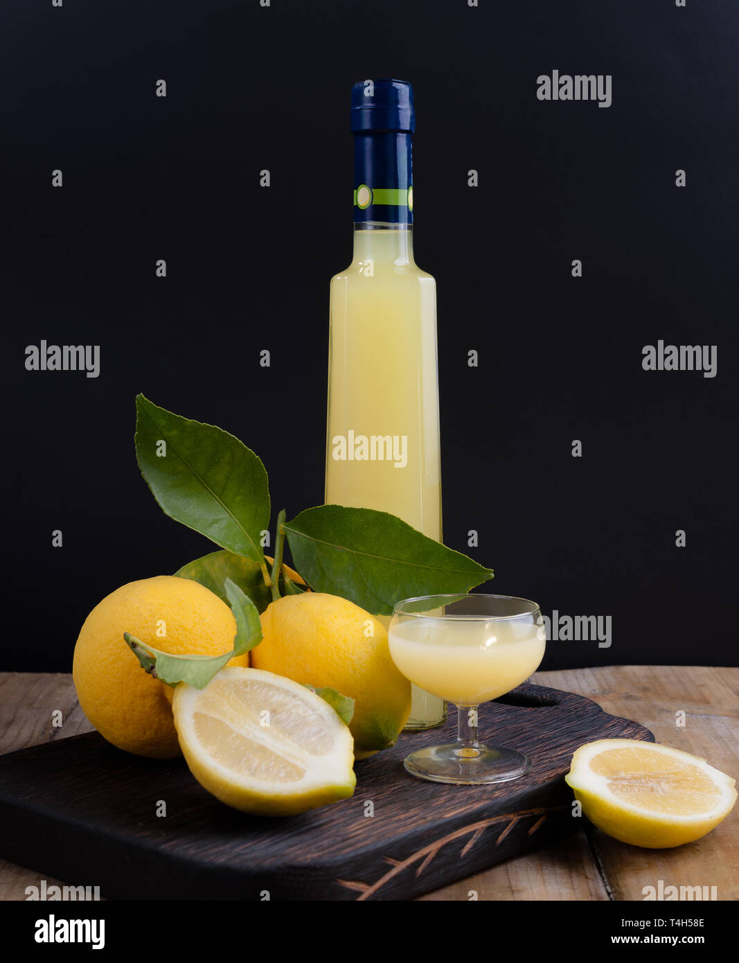 Lemoncello in a bottle on a black background, Traditional Italian ...
