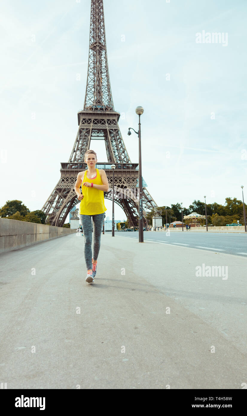 healthy woman in fitness clothes jogging against clear view of the ...