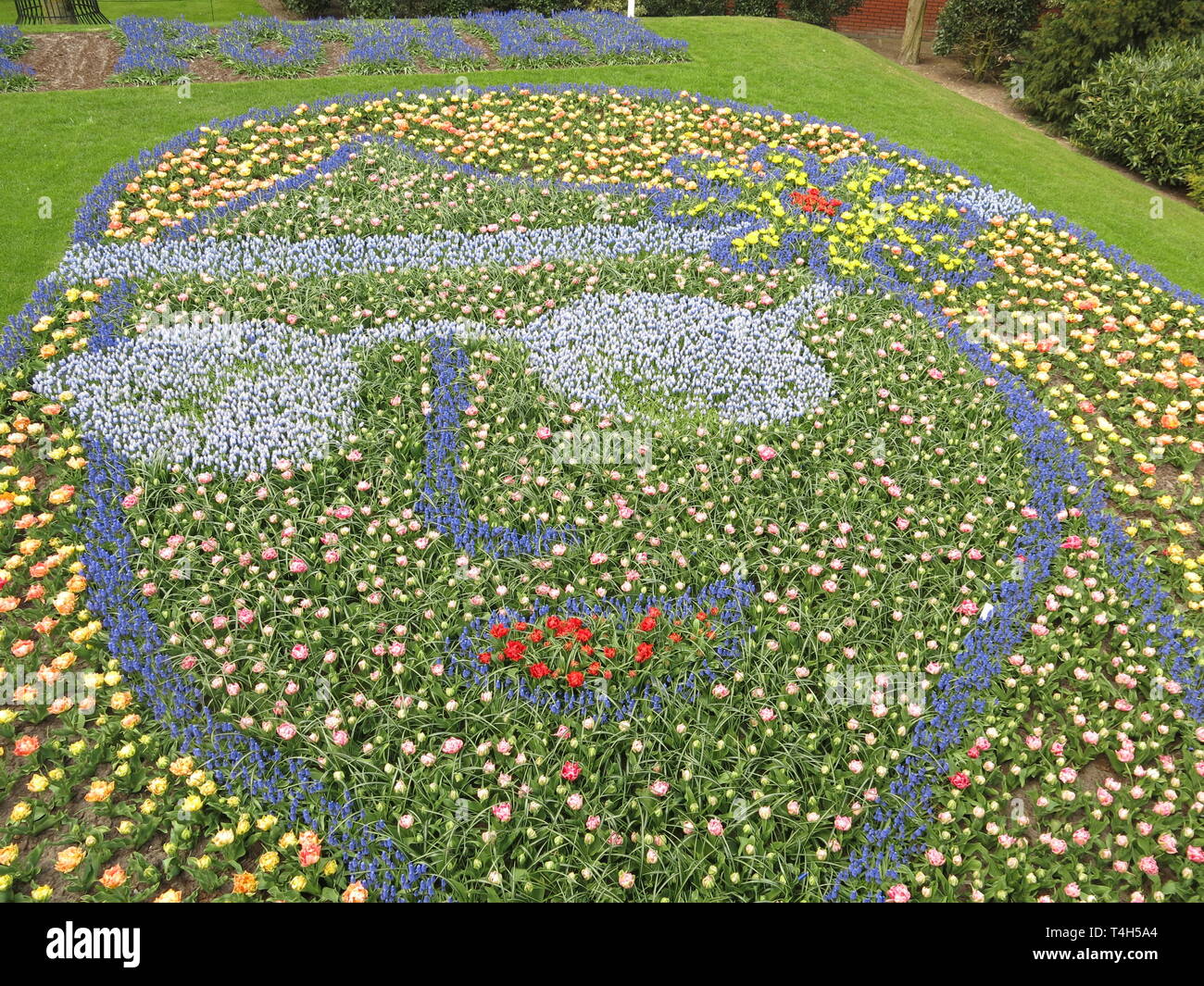 A flower bed display of planted bulbs featuring the visage of John ...