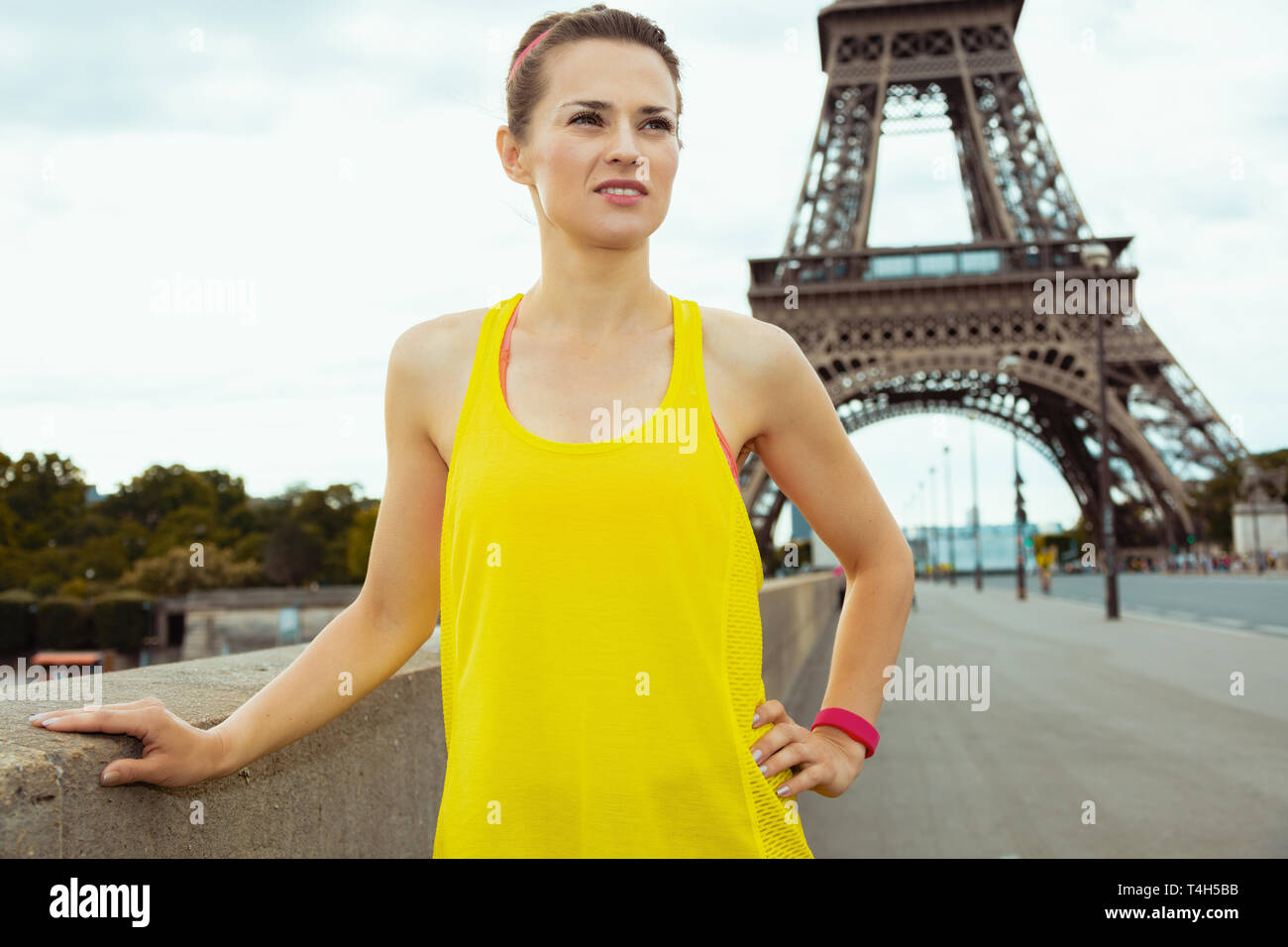 fit woman in fitness clothes not far from Eiffel tower in Paris, France ...
