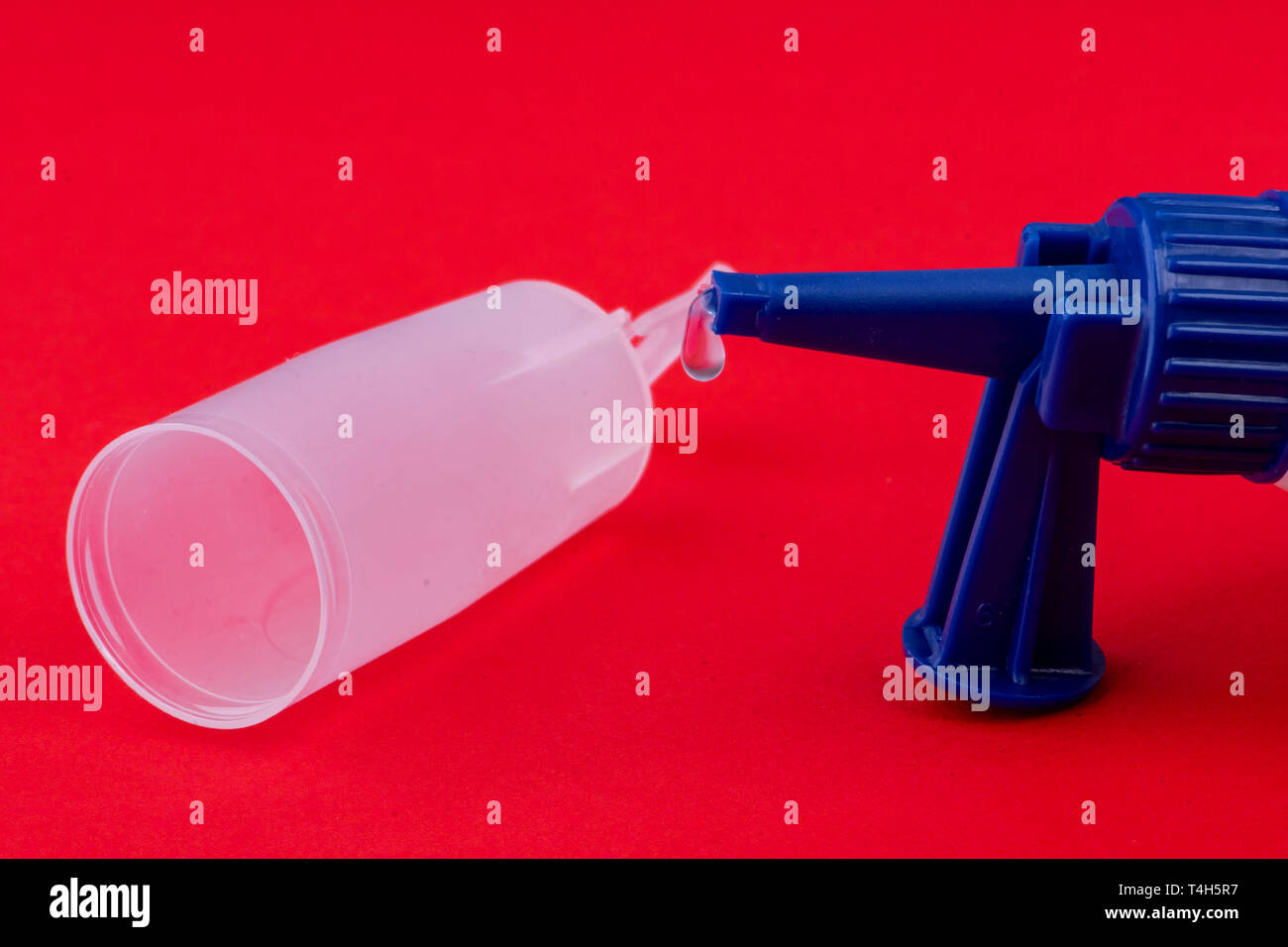 Adhesive tube with blue lid on white rustic wood background for craft ...