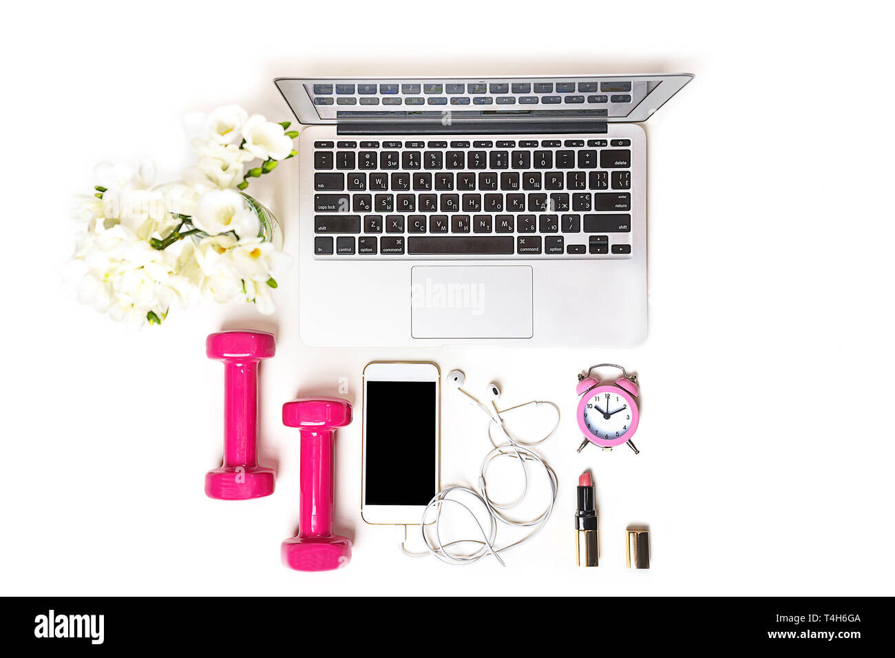 Women's workspace with laptop computer notebook, fitness equipment pink ...