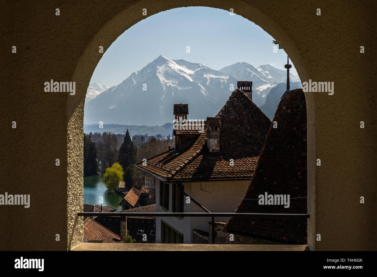 View of the Swiss Alps through a window in spring in the swiss town of ...