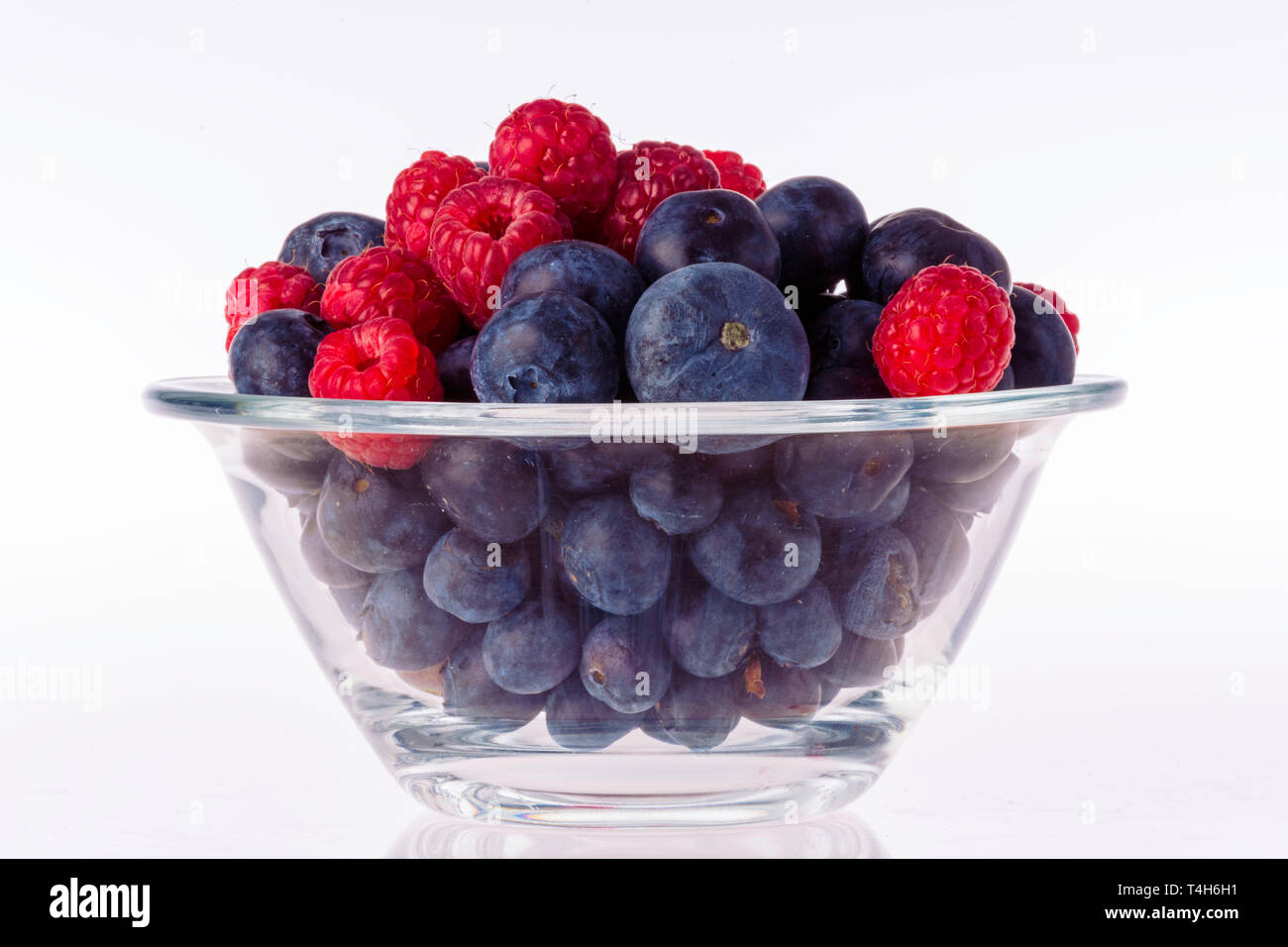 Raspberries and blueberries in the glass bowl Stock Photo - Alamy