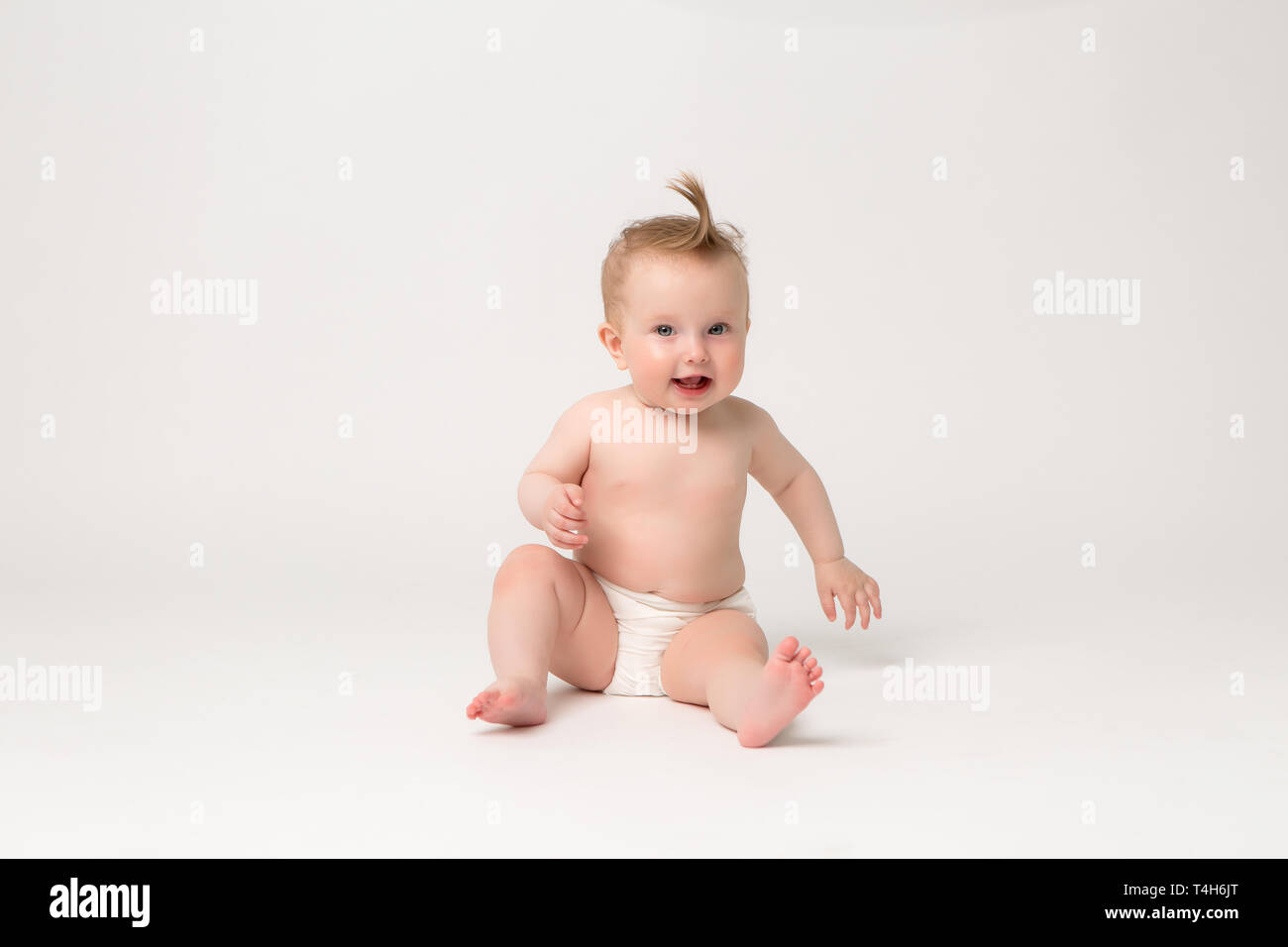 portrait of a baby in diapers on a white background,Cute baby girl ...