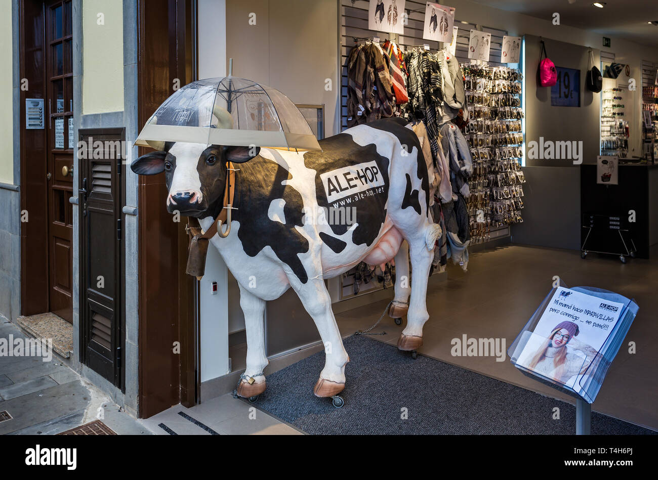 Large life size model of dairy cow with umbrella outside shop in Puerto ...