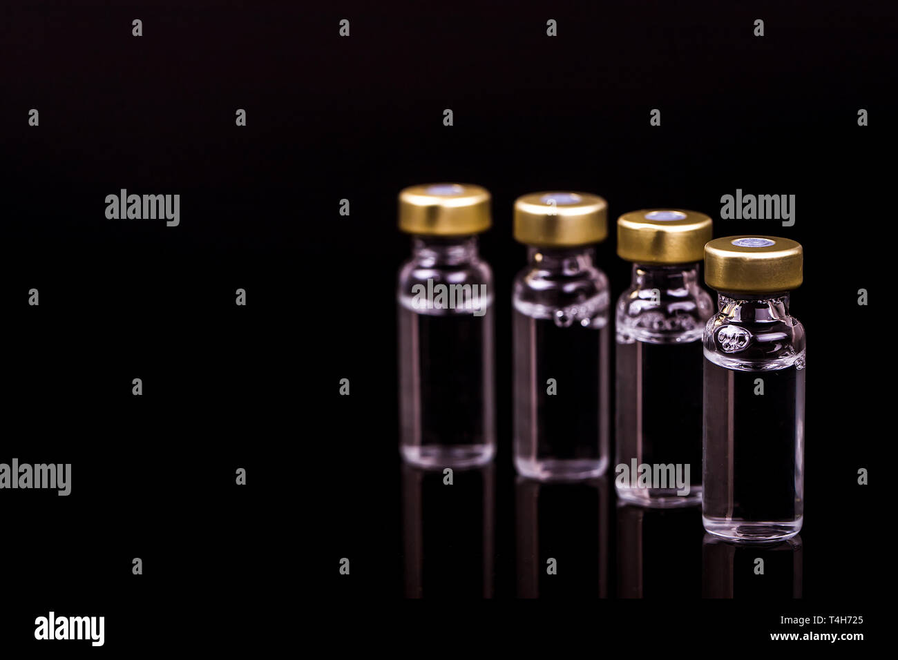 Glass vial medical close-up isolated on a black - Image Stock Photo - Alamy