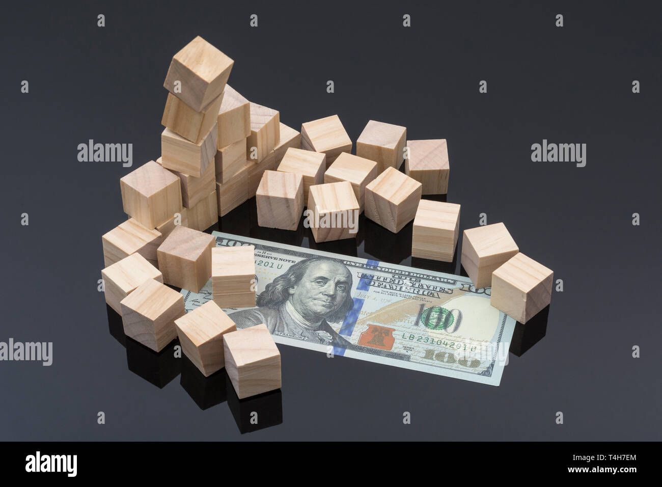 U.S. 100 Dollar bill with pile of wooden bricks. For Wall Street crash ...