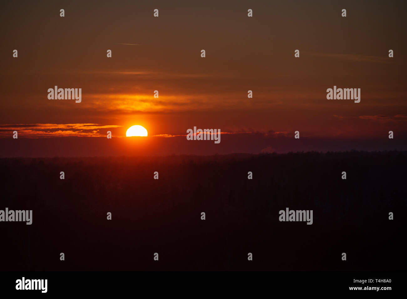 colorful sunset light over fields of snow in winter in countryside ...