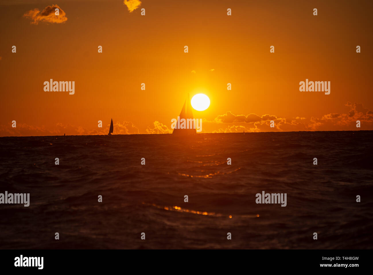 dark red sunset over sea in evening with broken clouds Stock Photo - Alamy