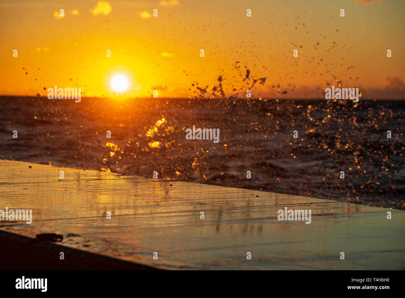 dark red sunset over sea in evening with broken clouds Stock Photo - Alamy