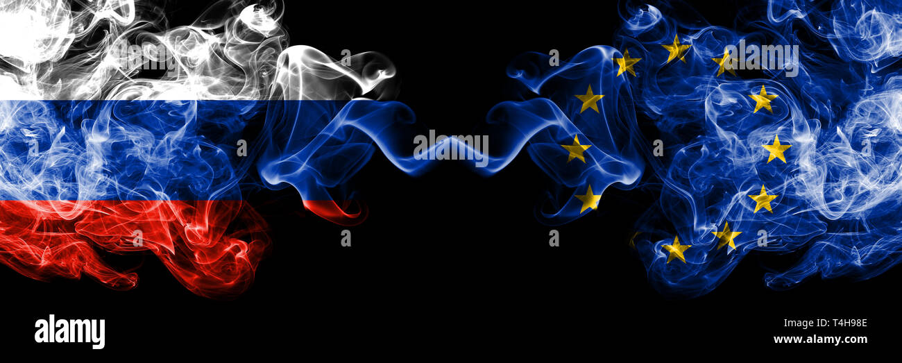 Russian vs European Union, EU smoke flags placed side by side. Thick ...