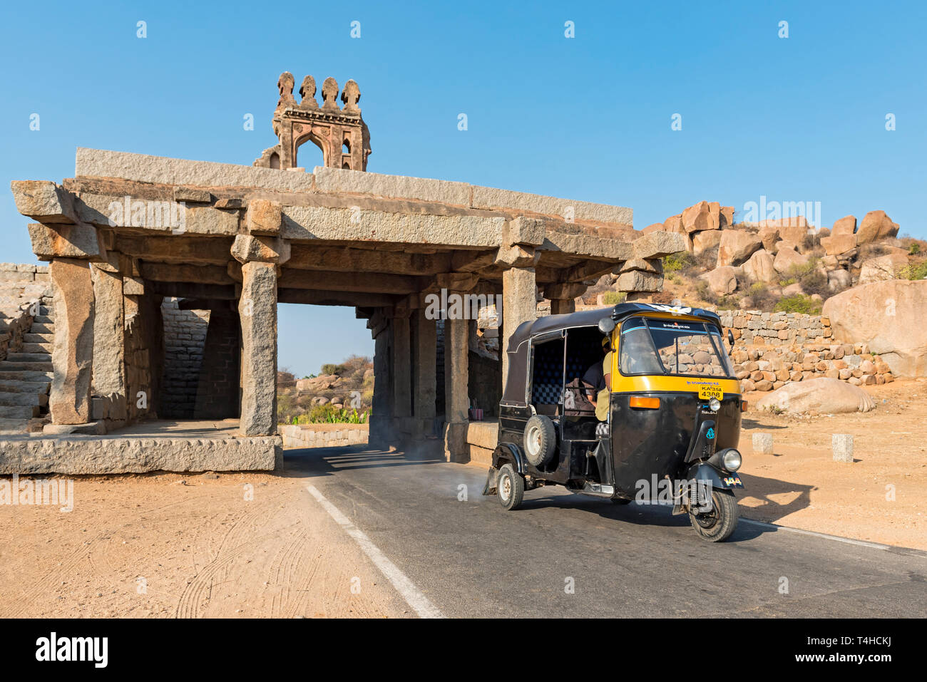 Auto-riksha drives through Talarigatta Gate, Hampi, India Stock Photo ...