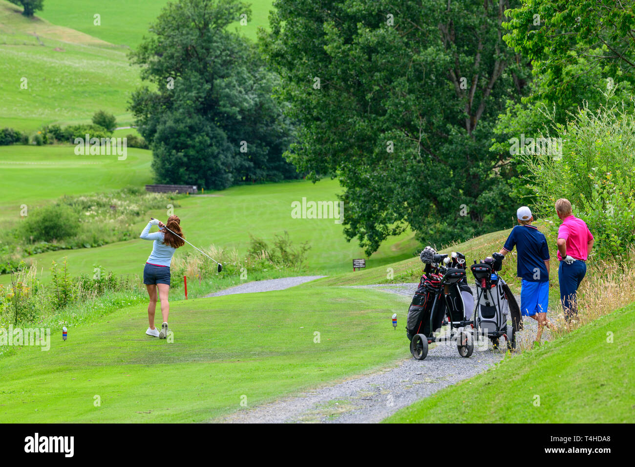 Golf as a family sport - family flight playing a parkland course Stock ...