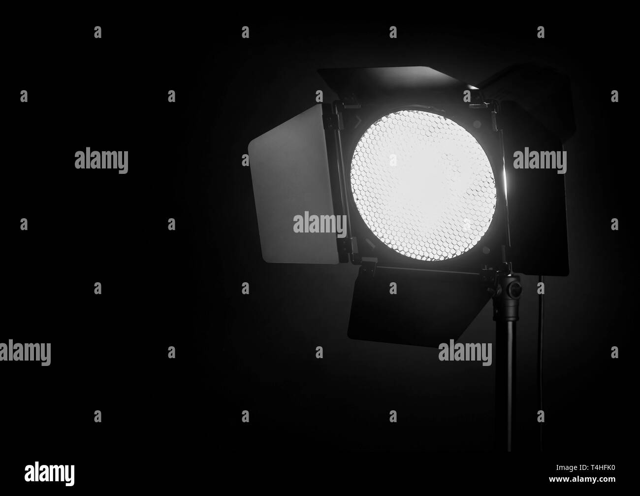 Studio flash with barndoors and grid on black background Stock Photo ...
