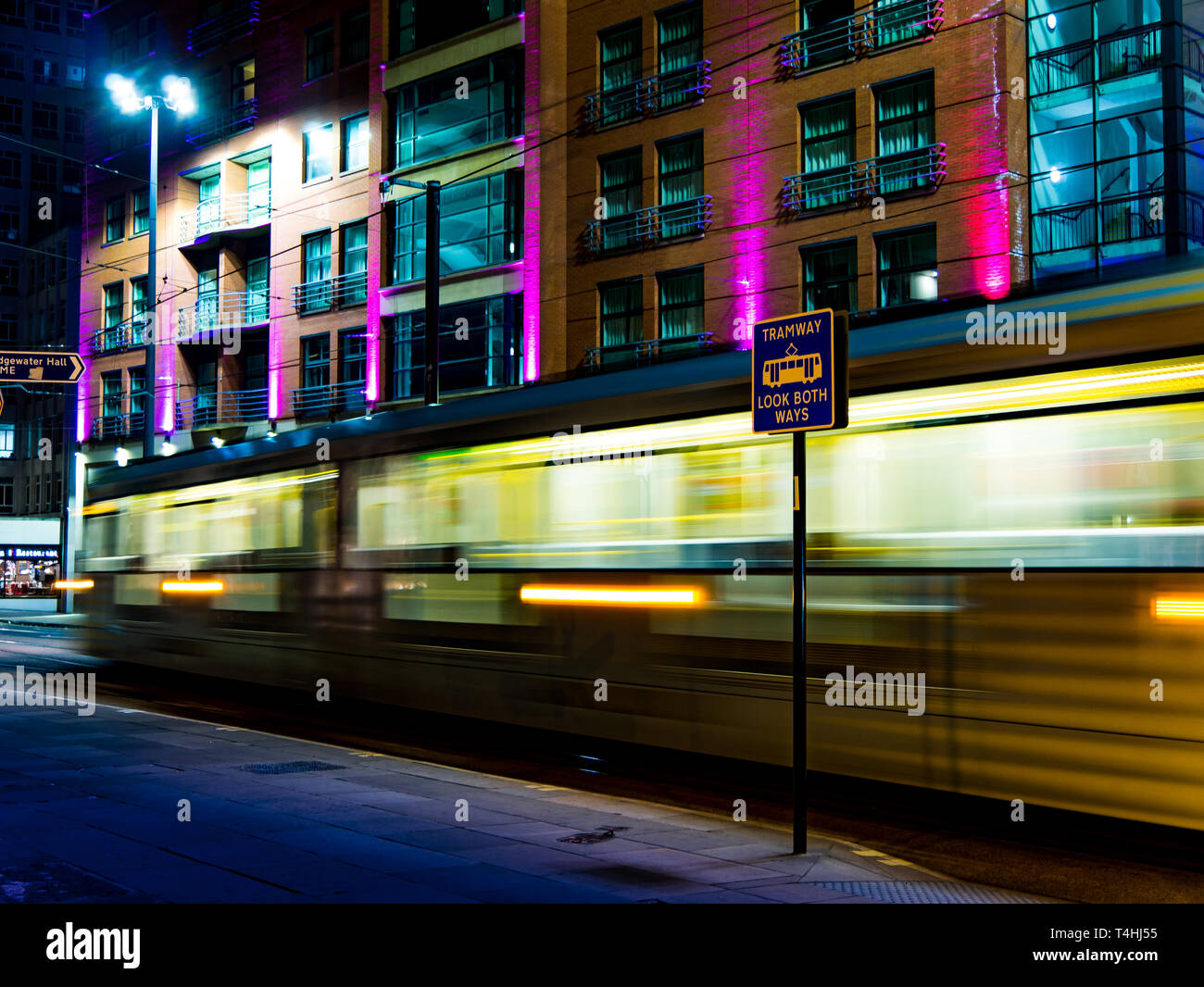 Colourful, neon, motion blur, yellow tram, night street scene ...