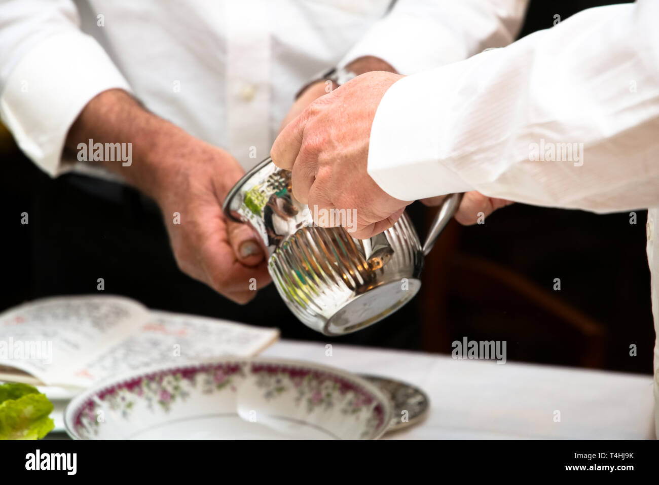 Two men washing hands at Passover. Jewish tradition Stock Photo - Alamy