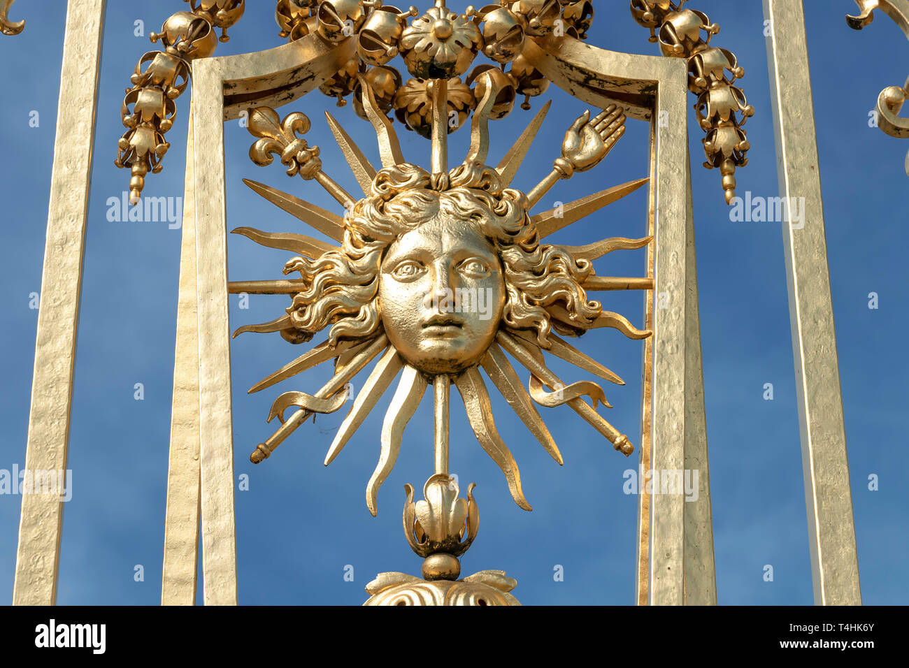 Detail of sun symbol in golden exterior fence at the facade of ...