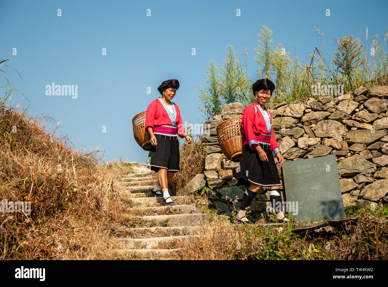 Local tribe women dressed in traditional clothing standing among the ...