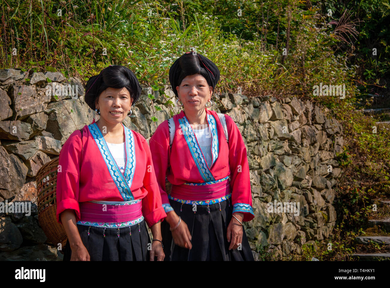 Local tribe women dressed in traditional clothing standing among the ...