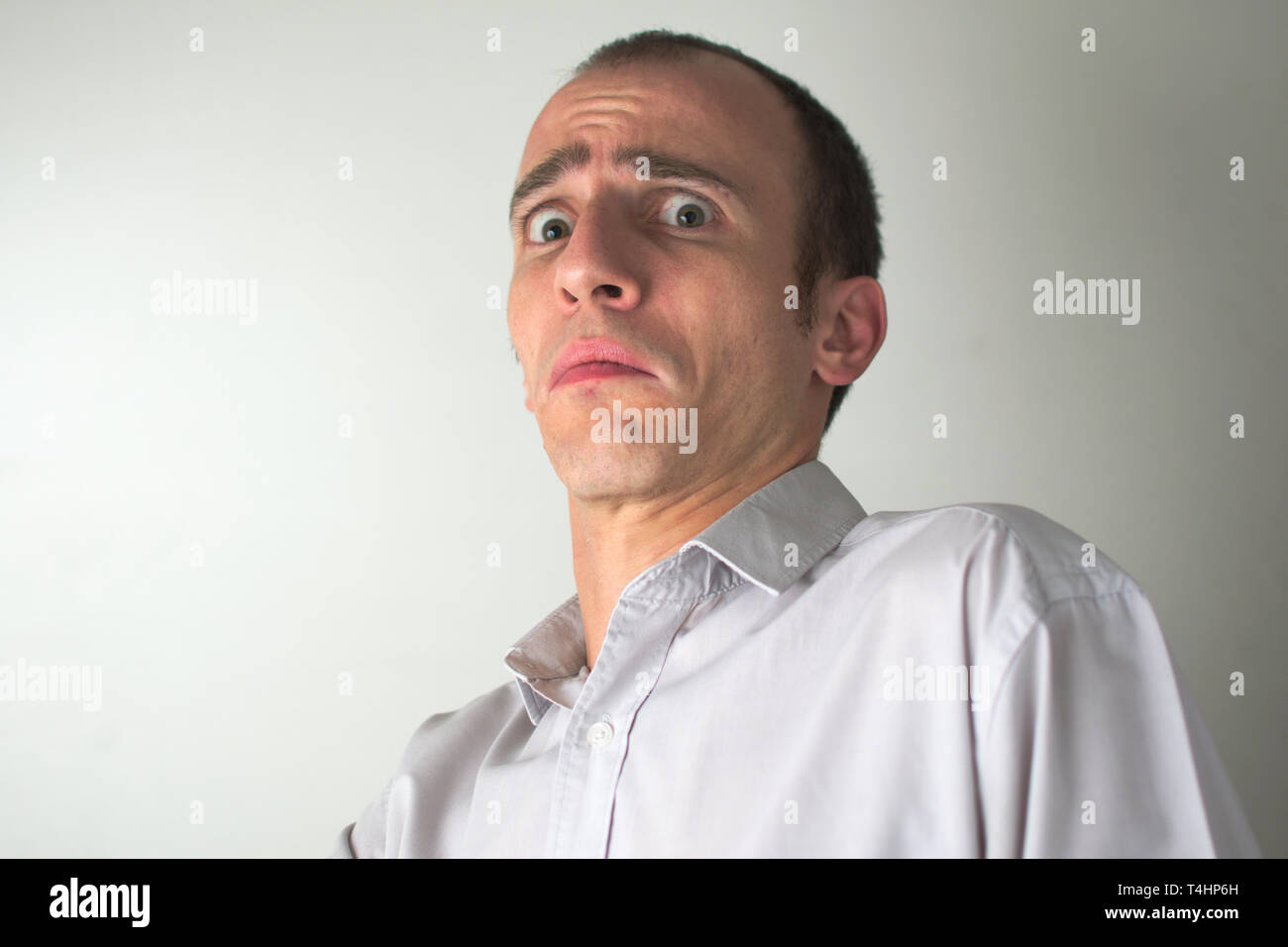 Studio shot of a business man with a fearful expression Stock Photo - Alamy