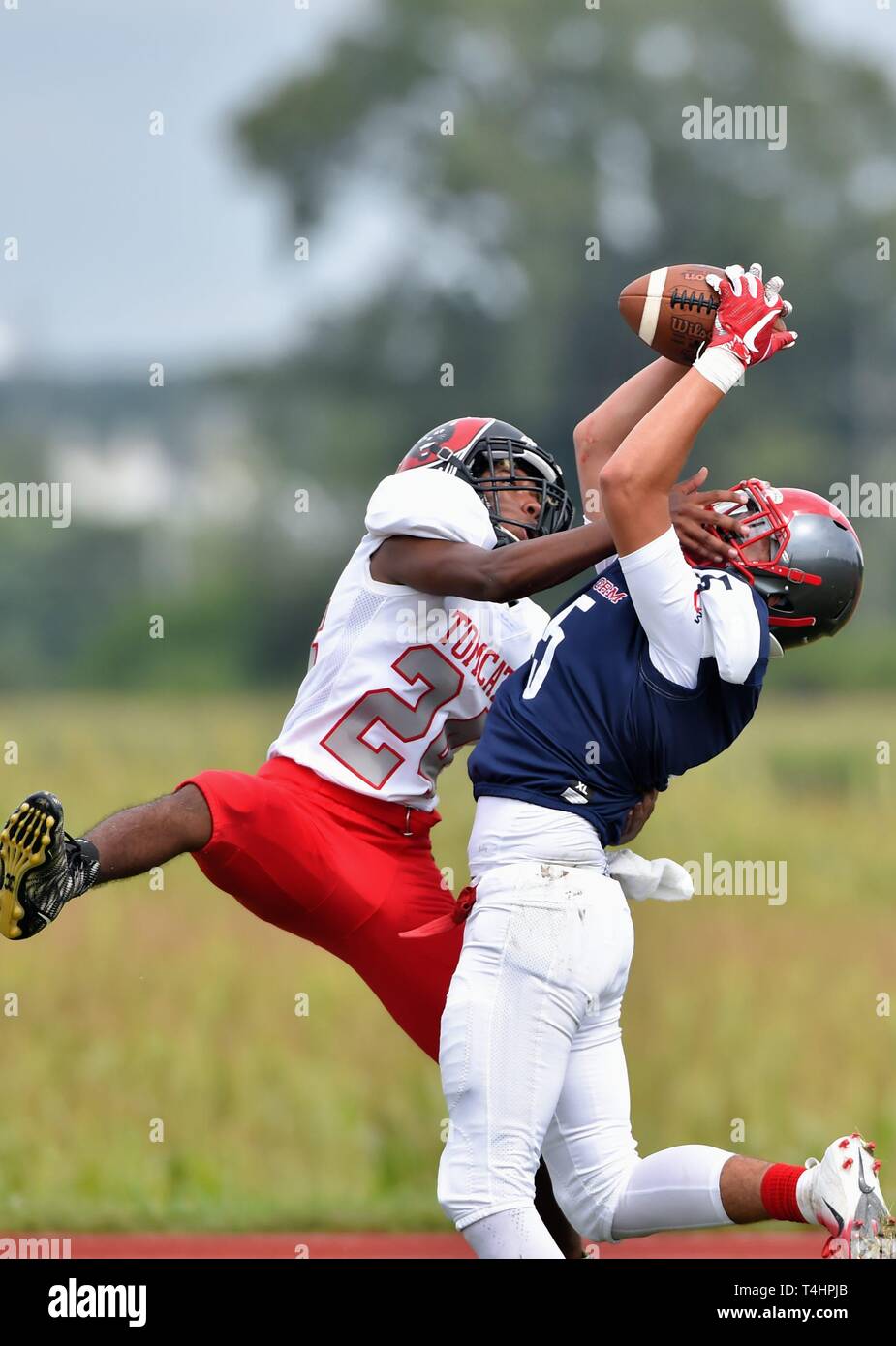 Receiver out battling a defensive back for a pass in a corner of the ...