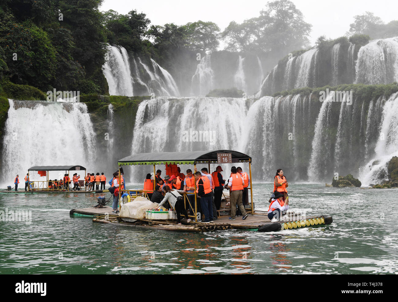 Daxin. 17th Apr, 2019. Tourists take bamboo rafts to visit Detian ...