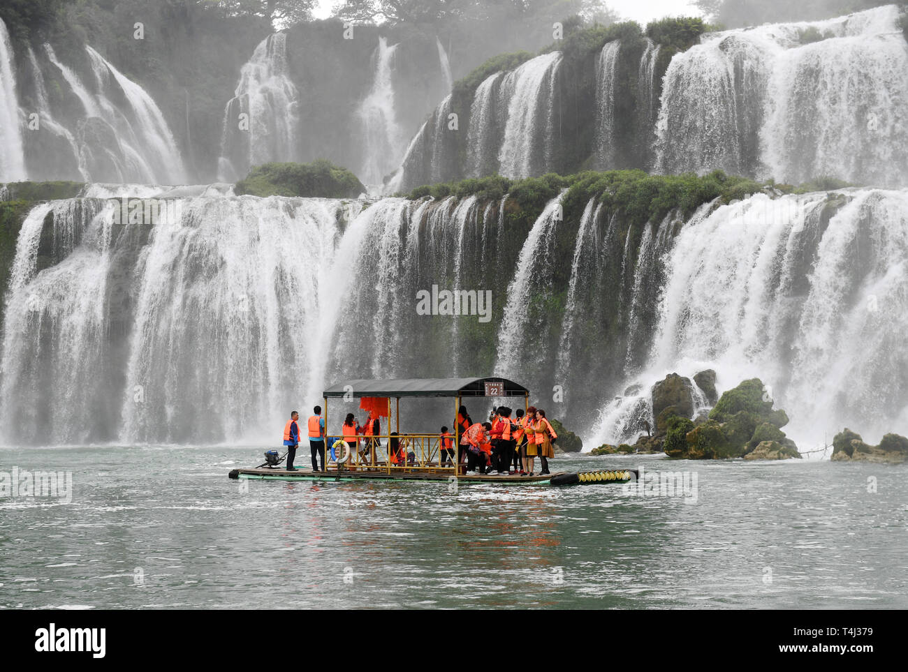 Daxin. 17th Apr, 2019. Tourists take a bamboo raft to visit Detian ...