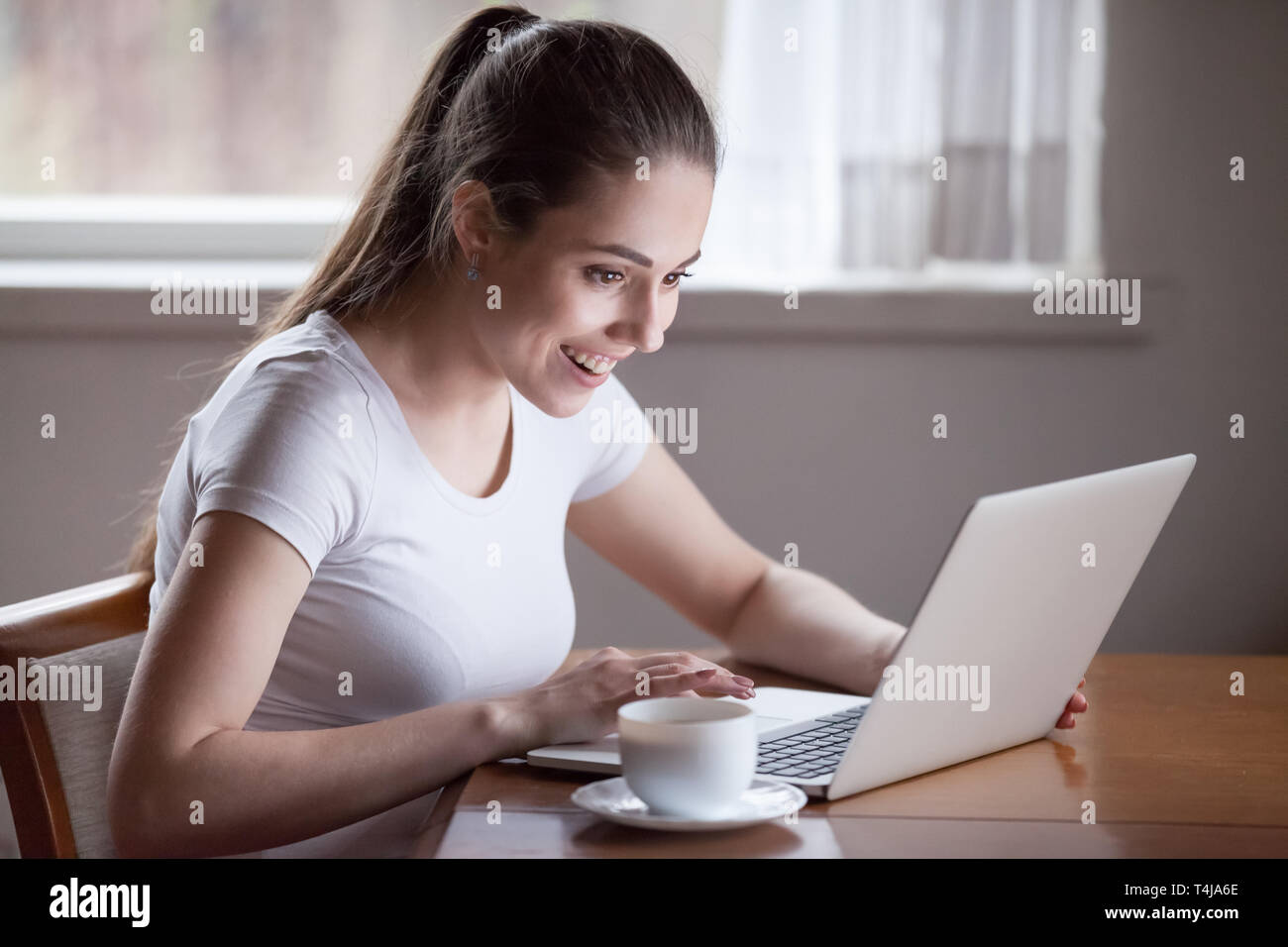 Excited woman reading good news on laptop screen at home Stock Photo ...