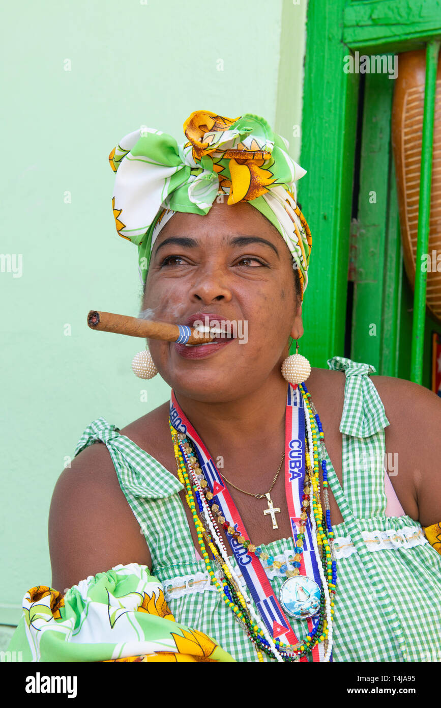 Cigar smoking lady posing for tourists in a door way near Convento de ...